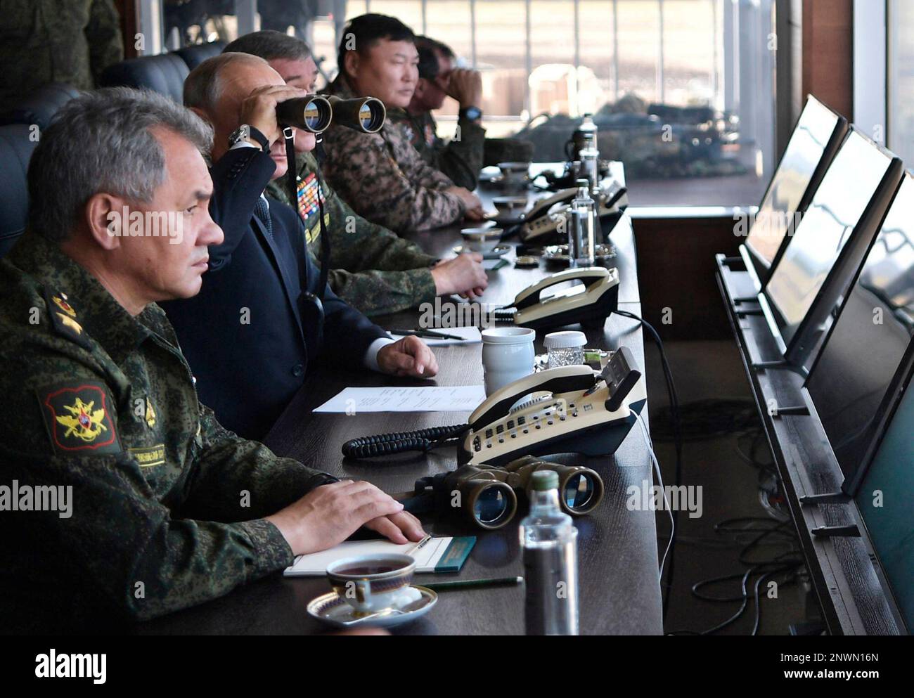 Russian President Vladimir Putin looks through a binocular as he visits ...