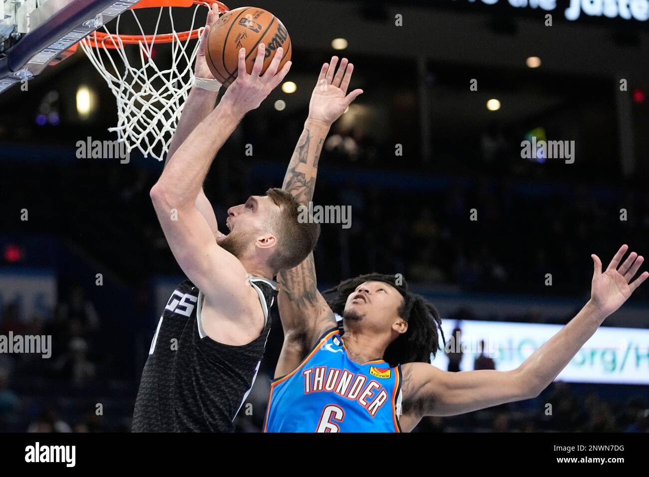 Sacramento Kings forward Domantas Sabonis, left, shoots in front of ...
