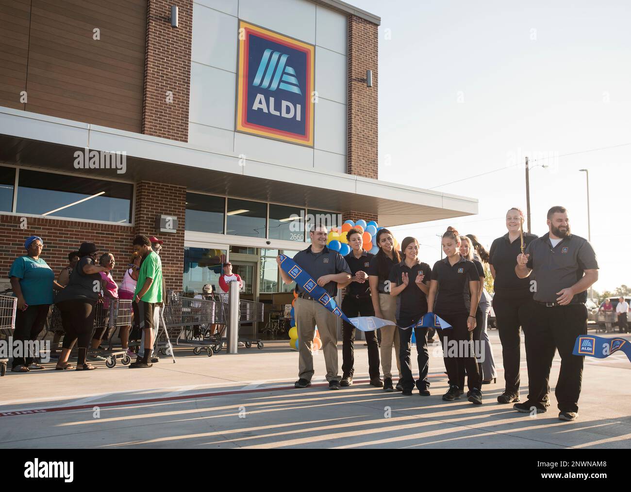 Store manager Kyle Kamp, far right, cuts the ribbon to celebrate ...