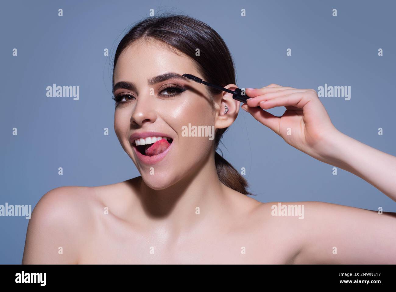 Female model shaping brown eyebrows. Woman eye with beautiful eyebrows. Perfect shaped brow ...