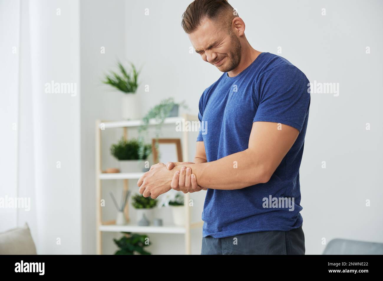 A man has pain in his arm, sprain of muscles and ligaments during ...