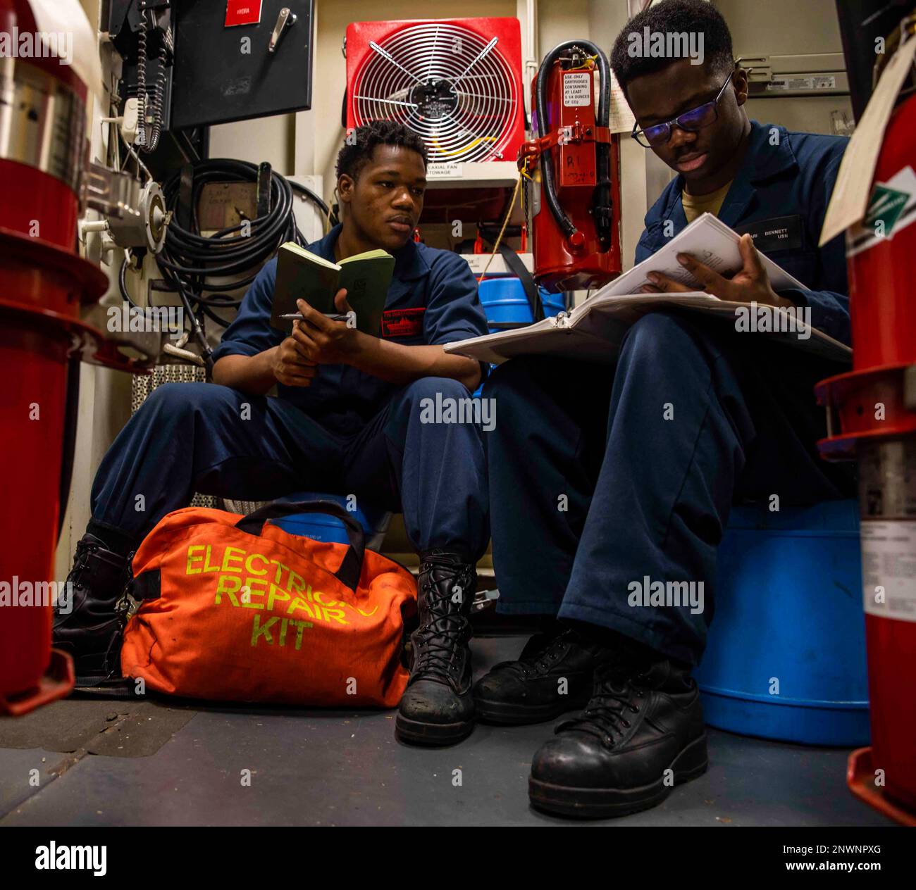 230104-N-XK047-1063 Damage Controlman Fireman Jamari Bennett, left, and ...