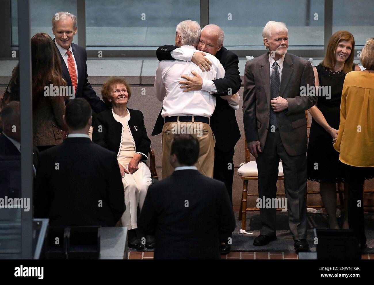 Jean Nealon, seated, smiles next to her children during a wake for ...