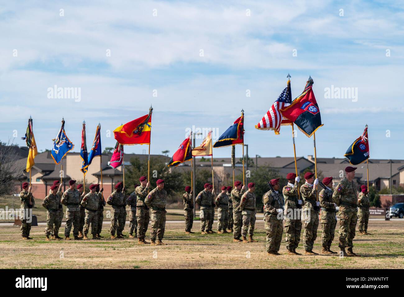 Battalion and brigade command teams and guidons stand at attention ...