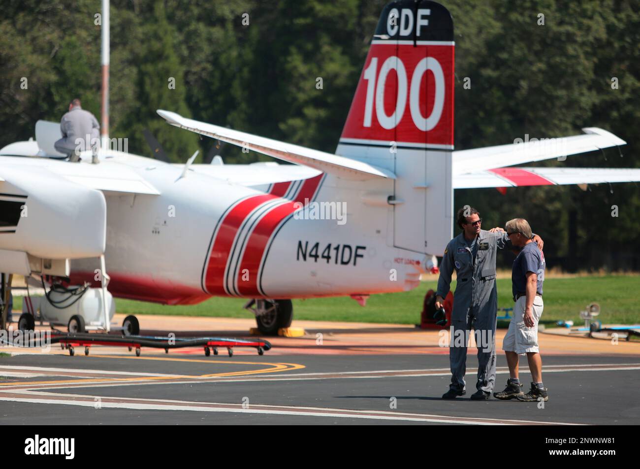 Cal Fire pilots greet each other while tanker 100 is being refueled in ...