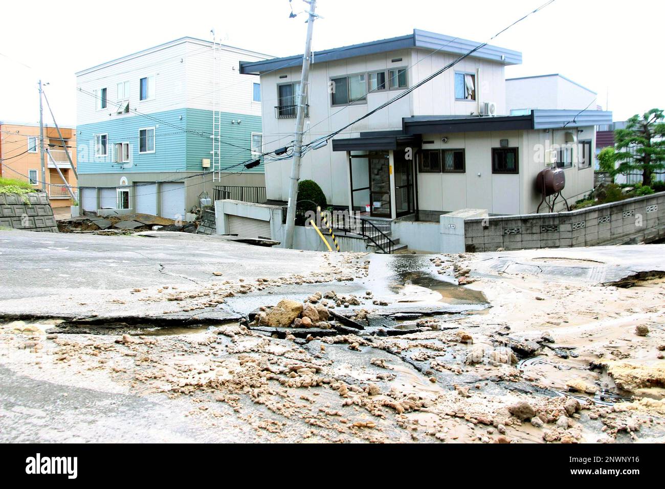 The road is destroyed in a phenomenon called liquefaction due to the ...