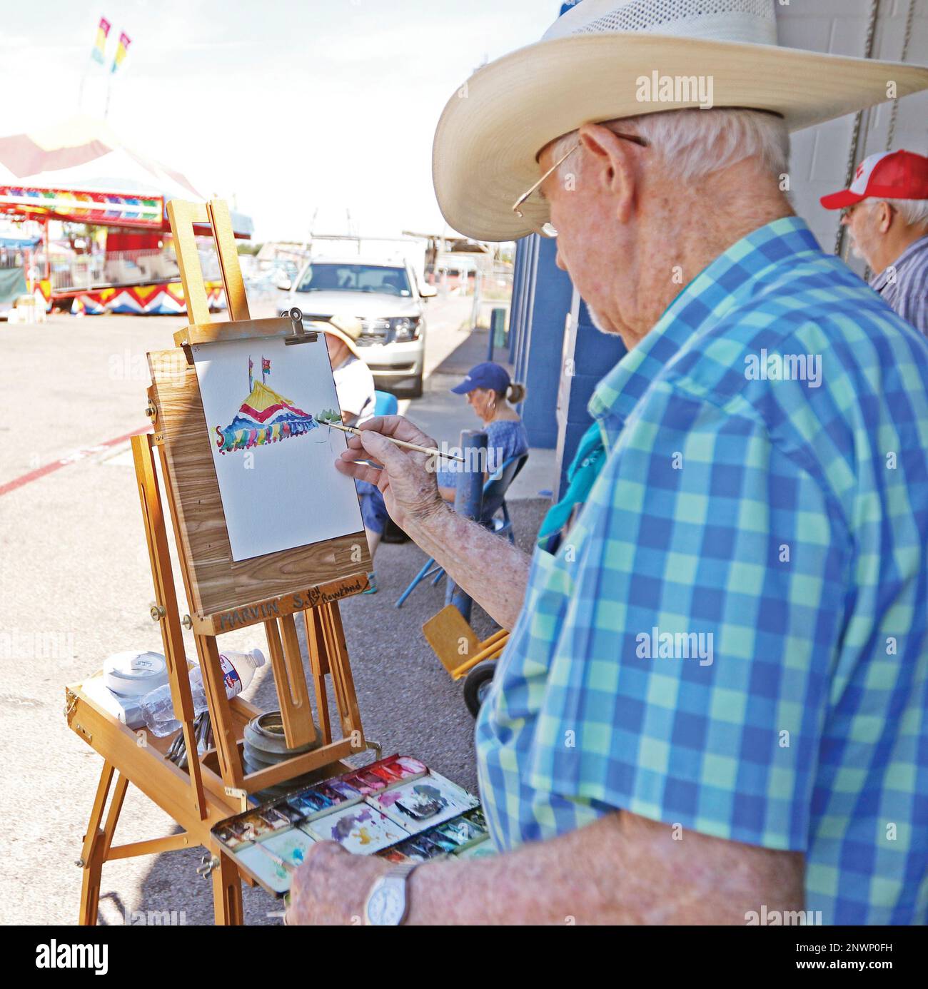 Ken Rowland paints a water color painting during a plain air painting ...