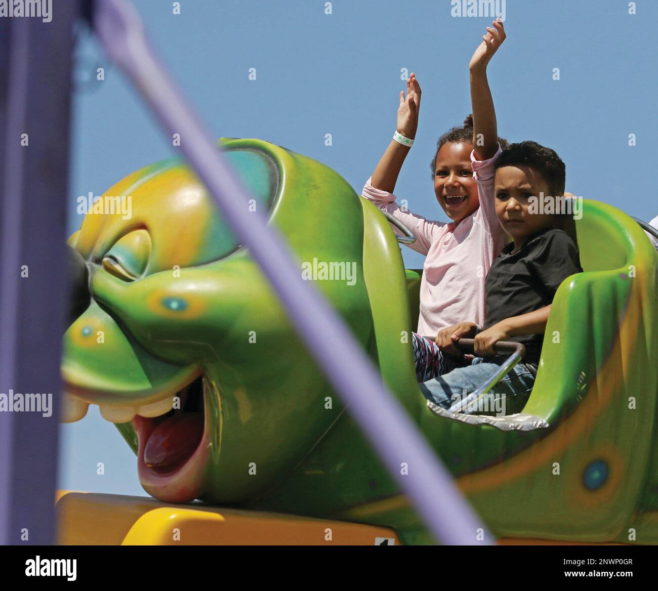 McKalynn Baker, 6, and her brother Dominic Baker, 5, ride a roller ...