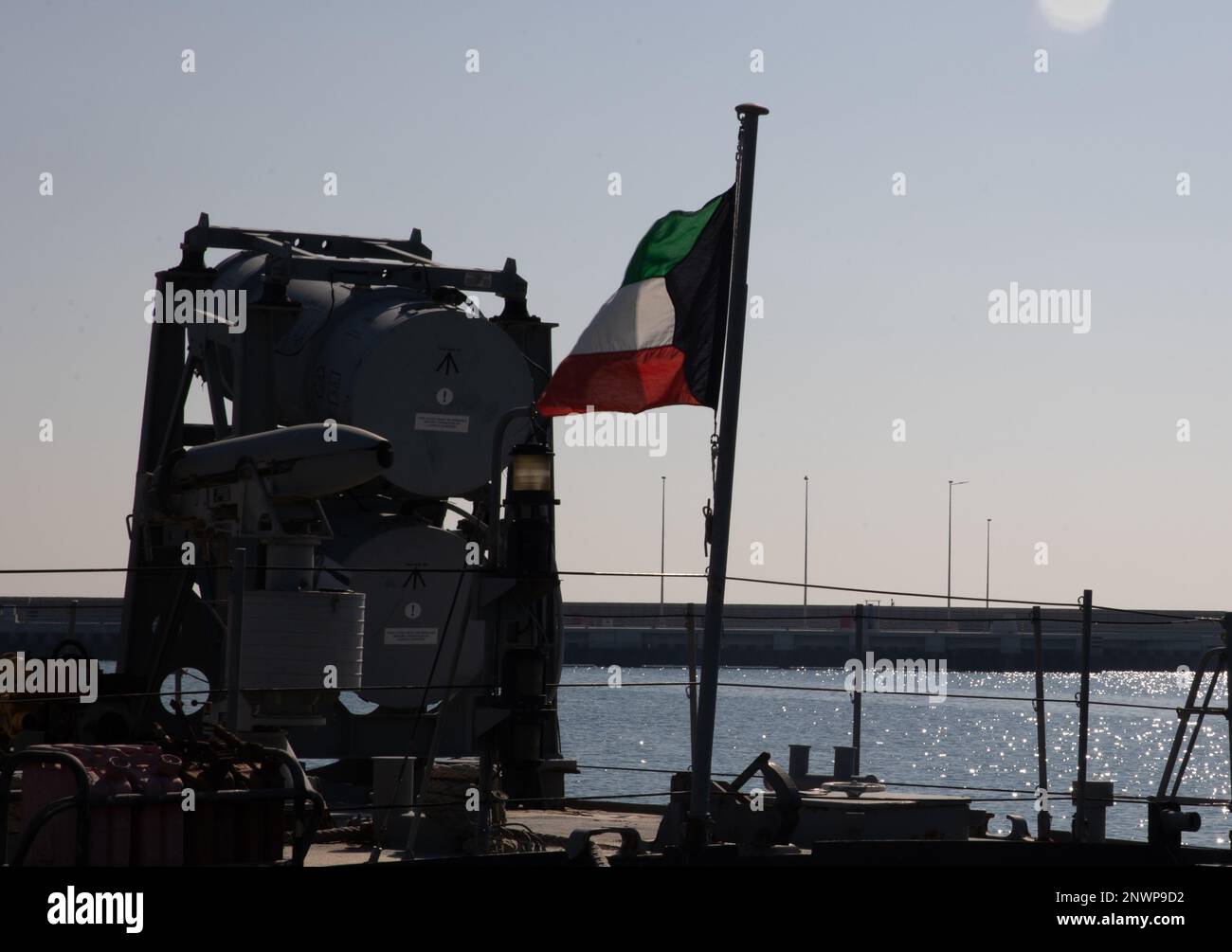 The Kuwait flag waves on a vessel at the Muhammed Al-Ahmed Naval Base ...