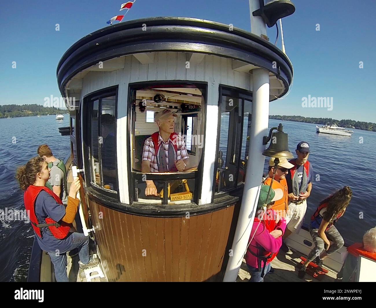 At the helm of the Sand Man tugboat, skipper Doug Eklund maneuvers the ...