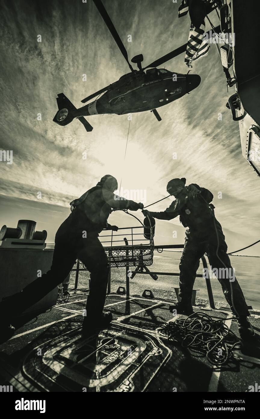 U.S. Coast Guard Seaman Eric Buckle, left, and Boatswains Mate 3rd ...