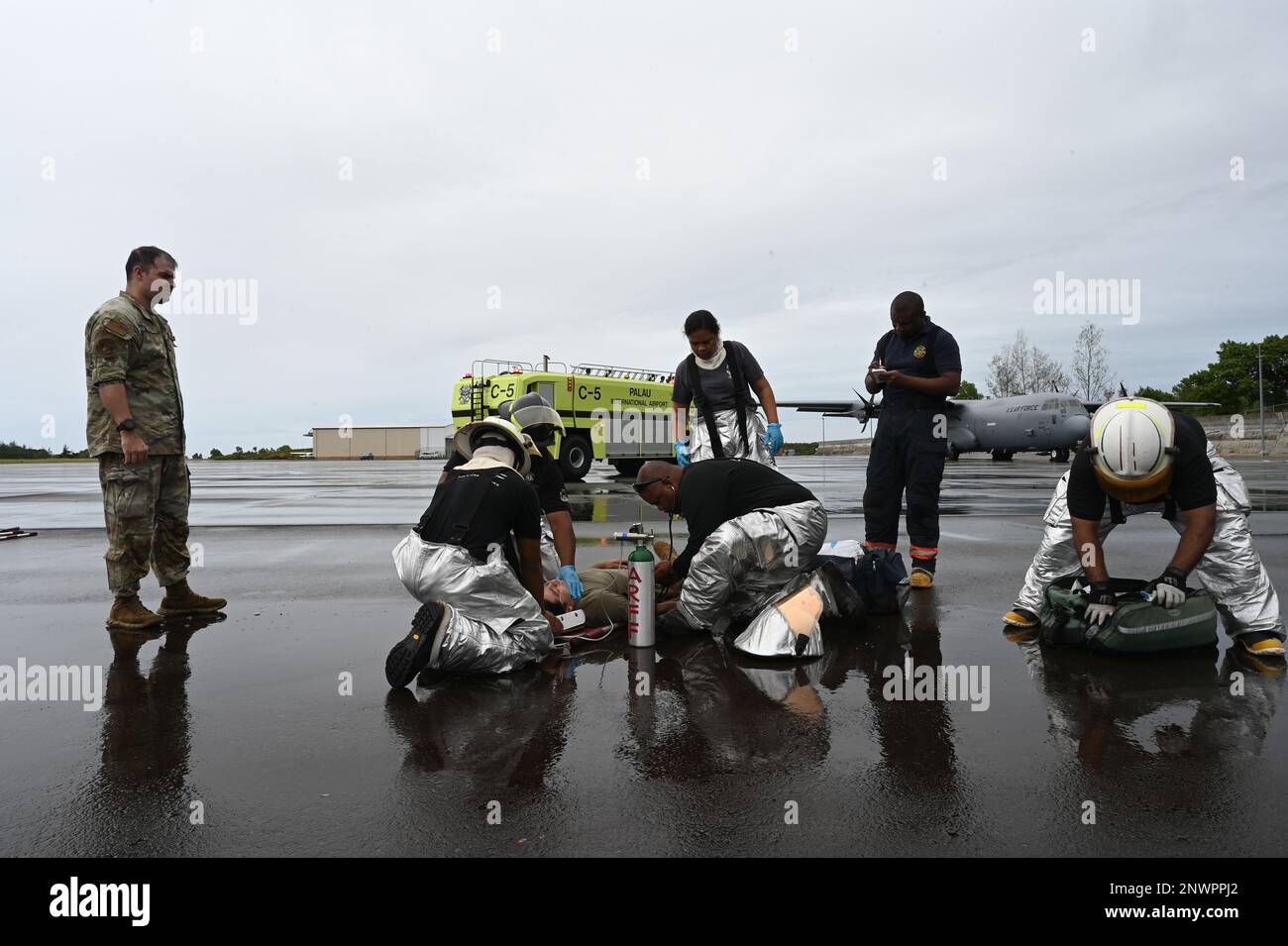 Palau International Fire fighters work to stabilize a simulated burn ...