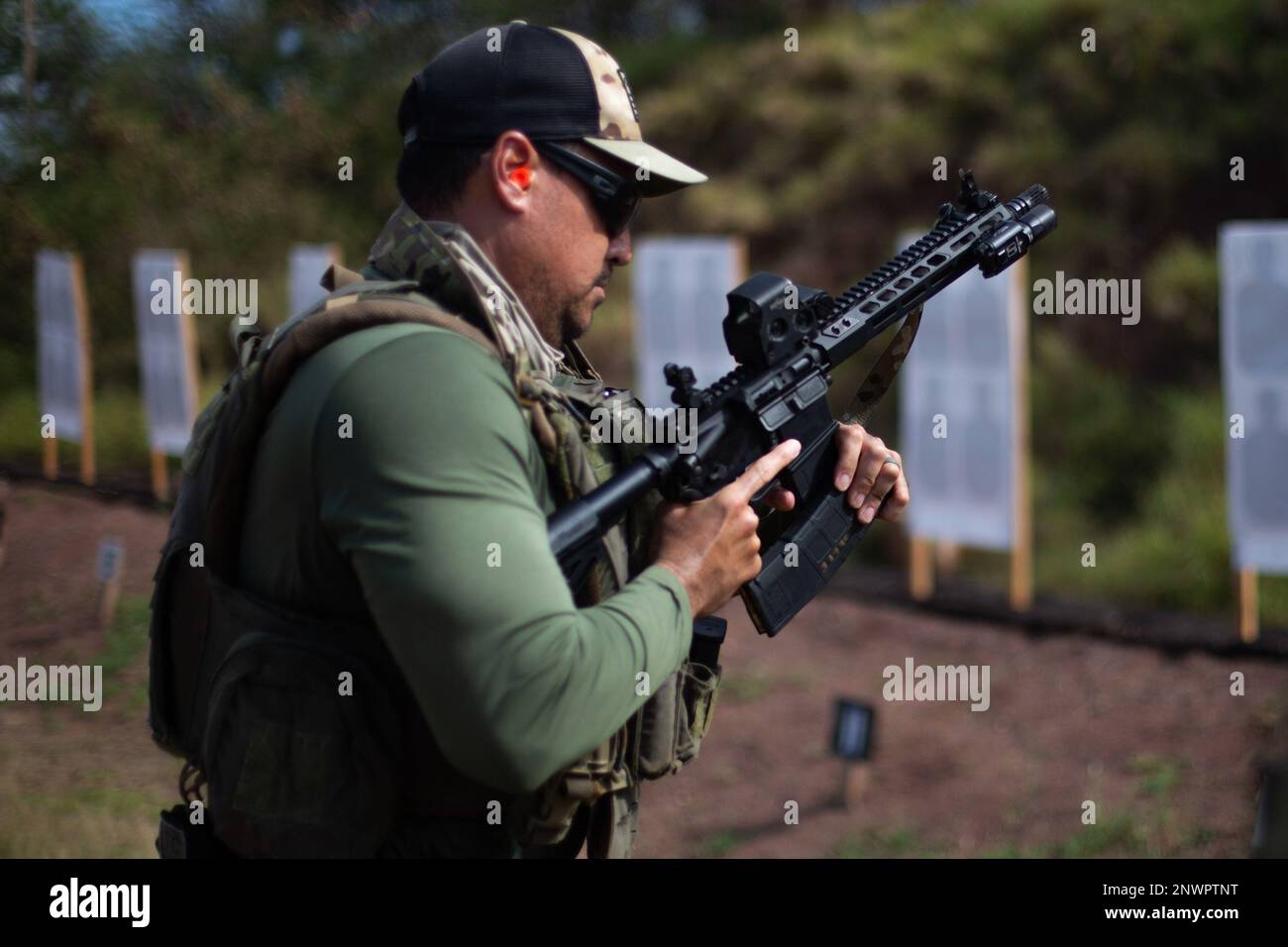 An officer with the Honolulu Police Department reloads an M4 service ...