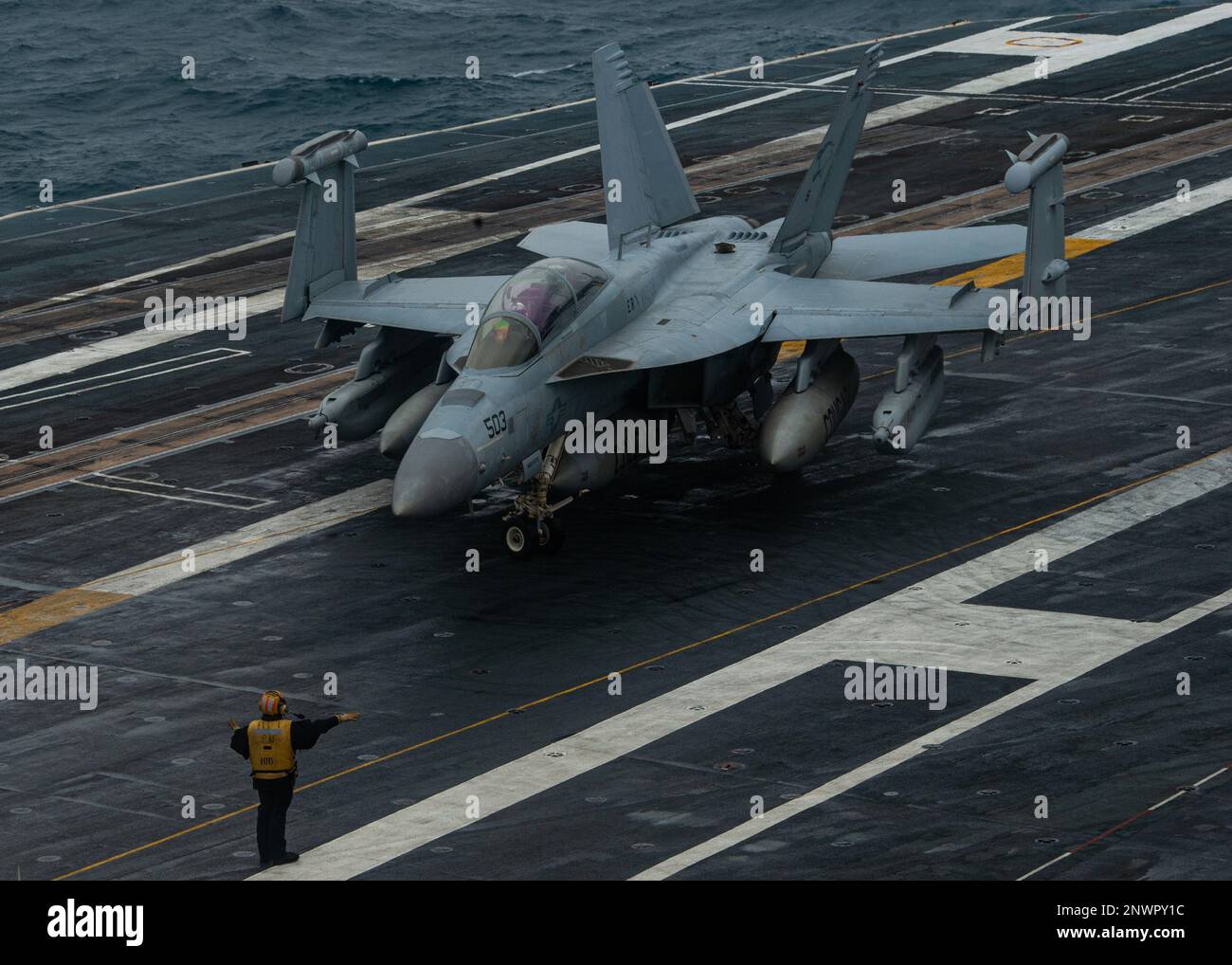 230127-N-MH015-1203 SOUTH CHINA SEA (Jan. 27, 2023) A U.S. Navy Sailor directs an E/A-18G ...