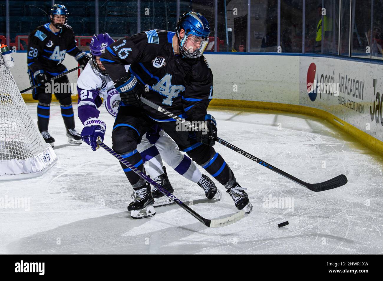 U.S. Air Force Academy -- Air Force's Sam Brennan takes the puck behind ...