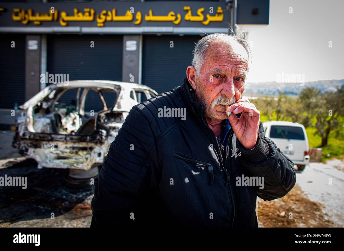 Huwara, Israel. 28th Feb, 2023. A Palestinian man smokes a cigaret as ...