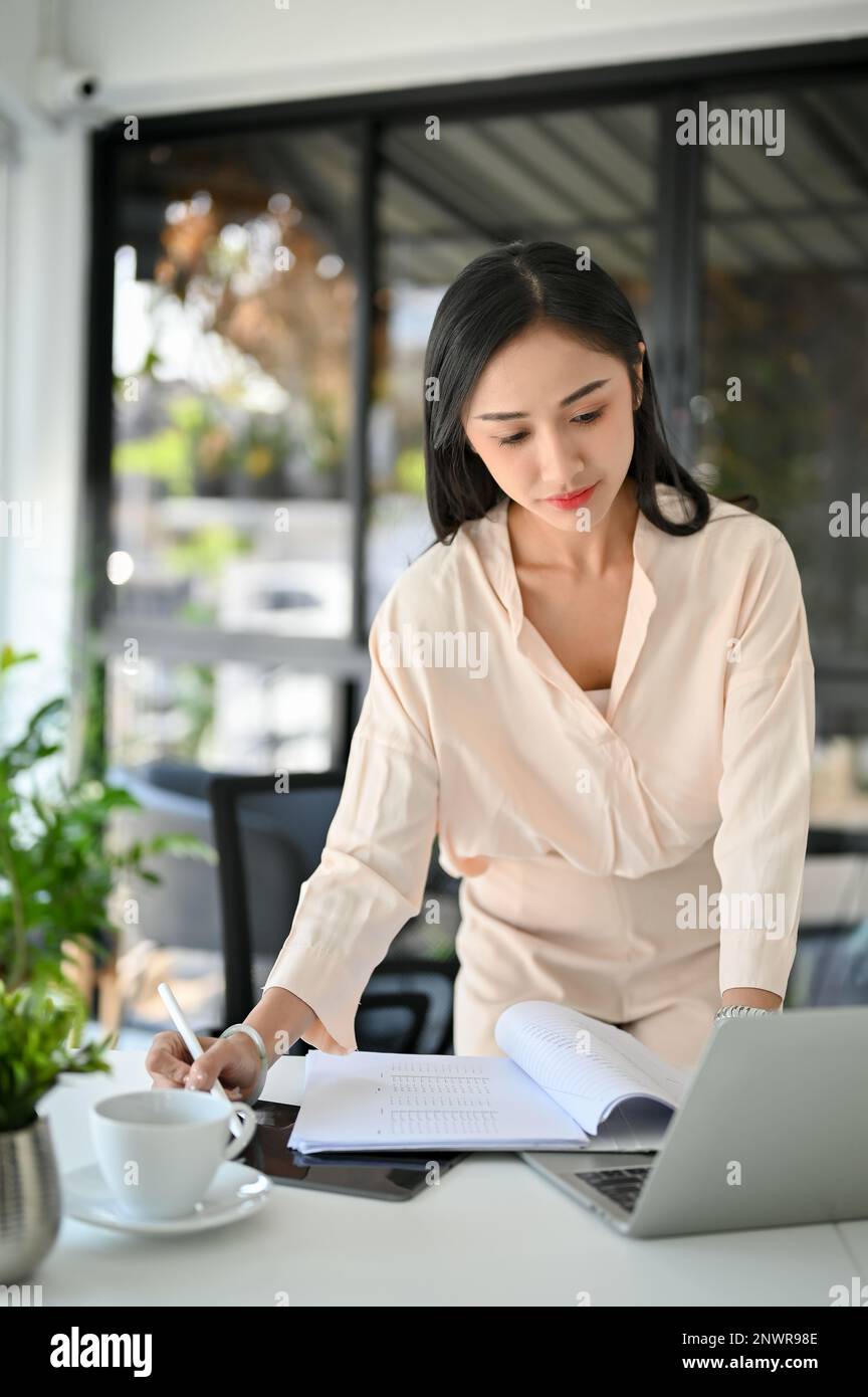 Busy and professional millennial Asian businesswoman or female manager ...