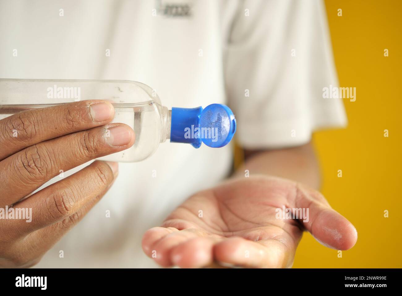 Young man pouring hair oil hi-res stock photography and images - Alamy