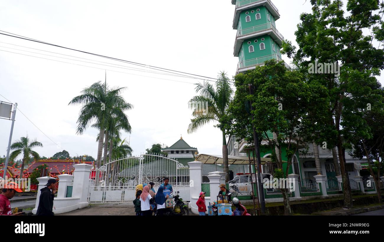The mosque building with green towers and the activities of residents ...