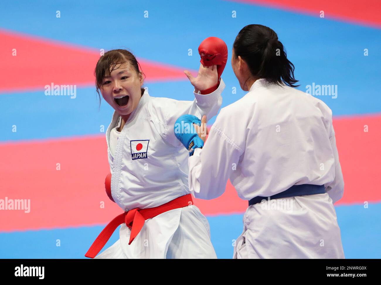 Japan's Ayumi UEKUSA (red) and China's GAO Mengmeng (blue) fight during ...