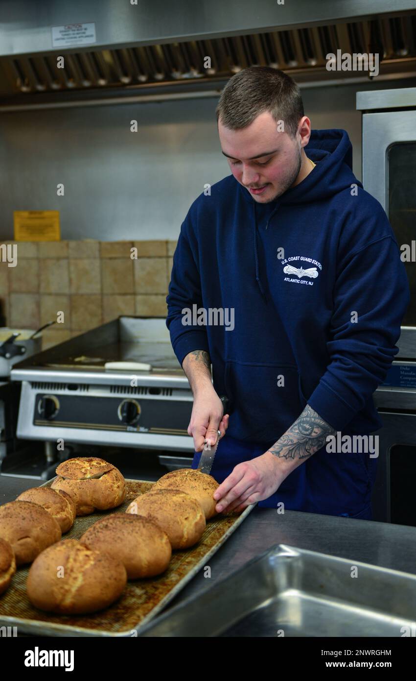 Petty Officer 3rd Class Brandon Brady prepares lunch for the crew at ...