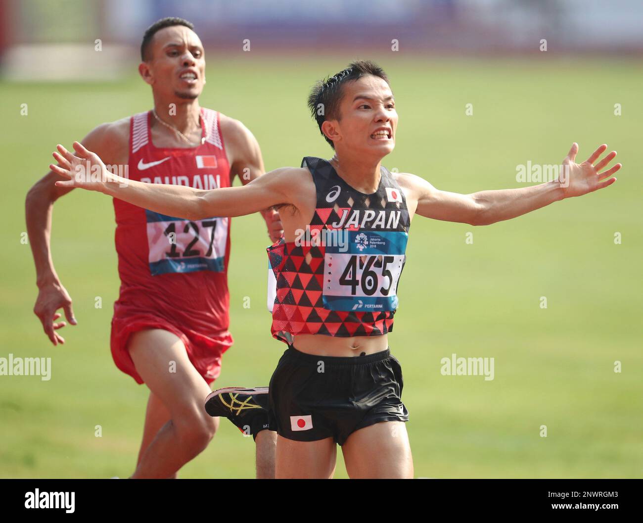 Japan's Hiroto Inoue (465) reacts as goaling the Athletics Men's Marathon of the Asian Games in ...