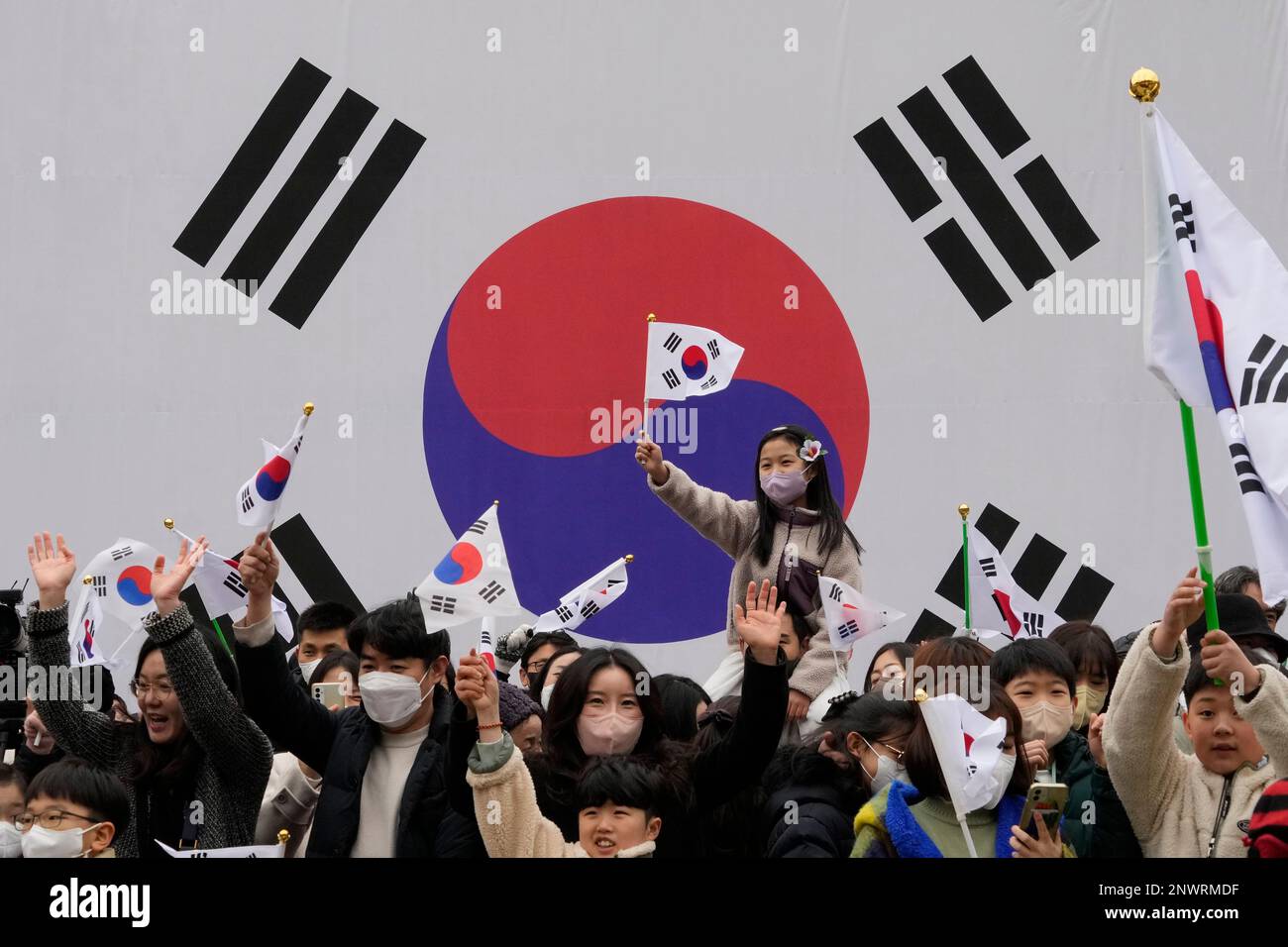 South Koreans wave national flags during a ceremony to celebrate the ...