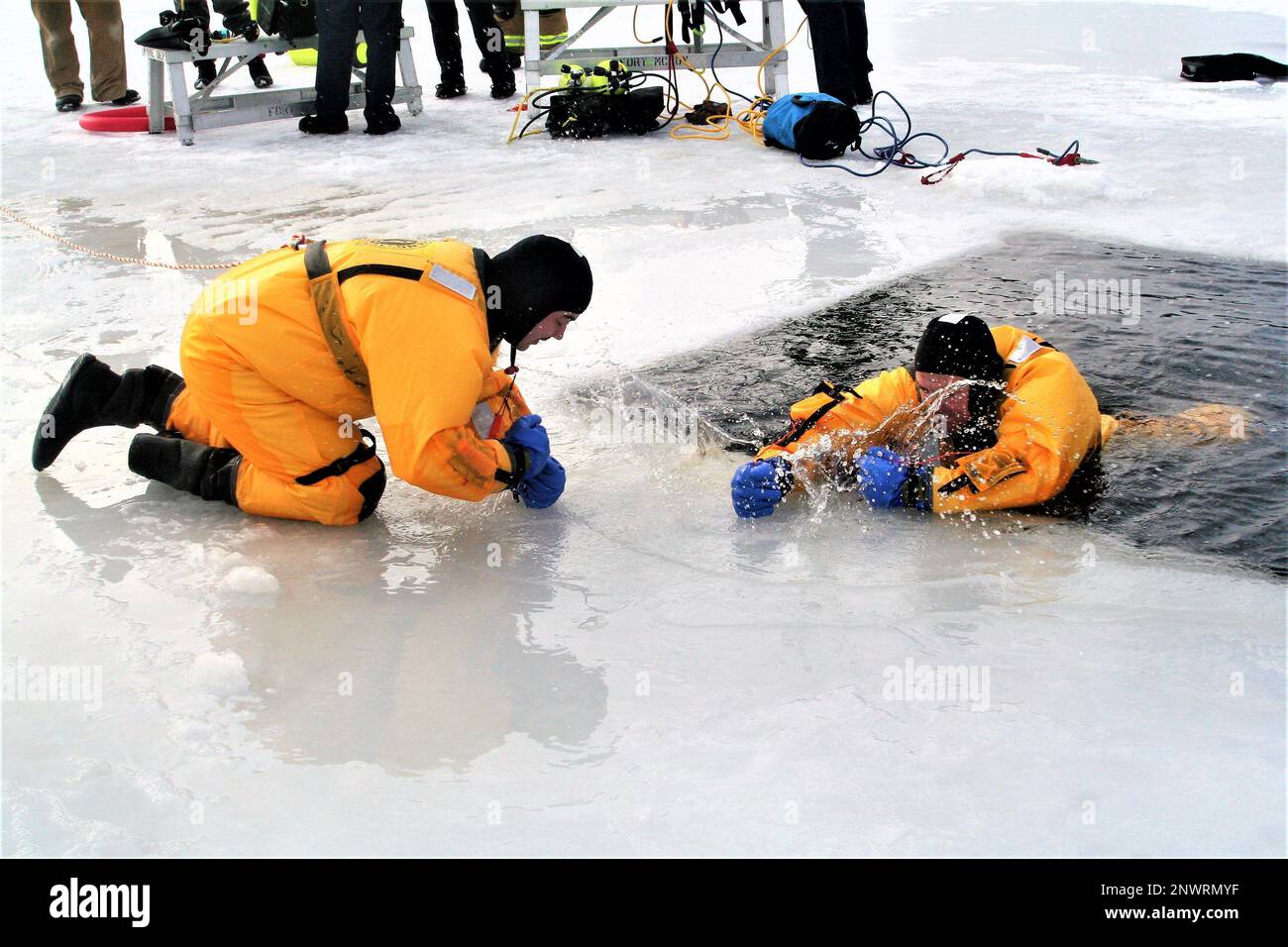 Firefighters wearing cold-water immersion protective suits hold surface ...