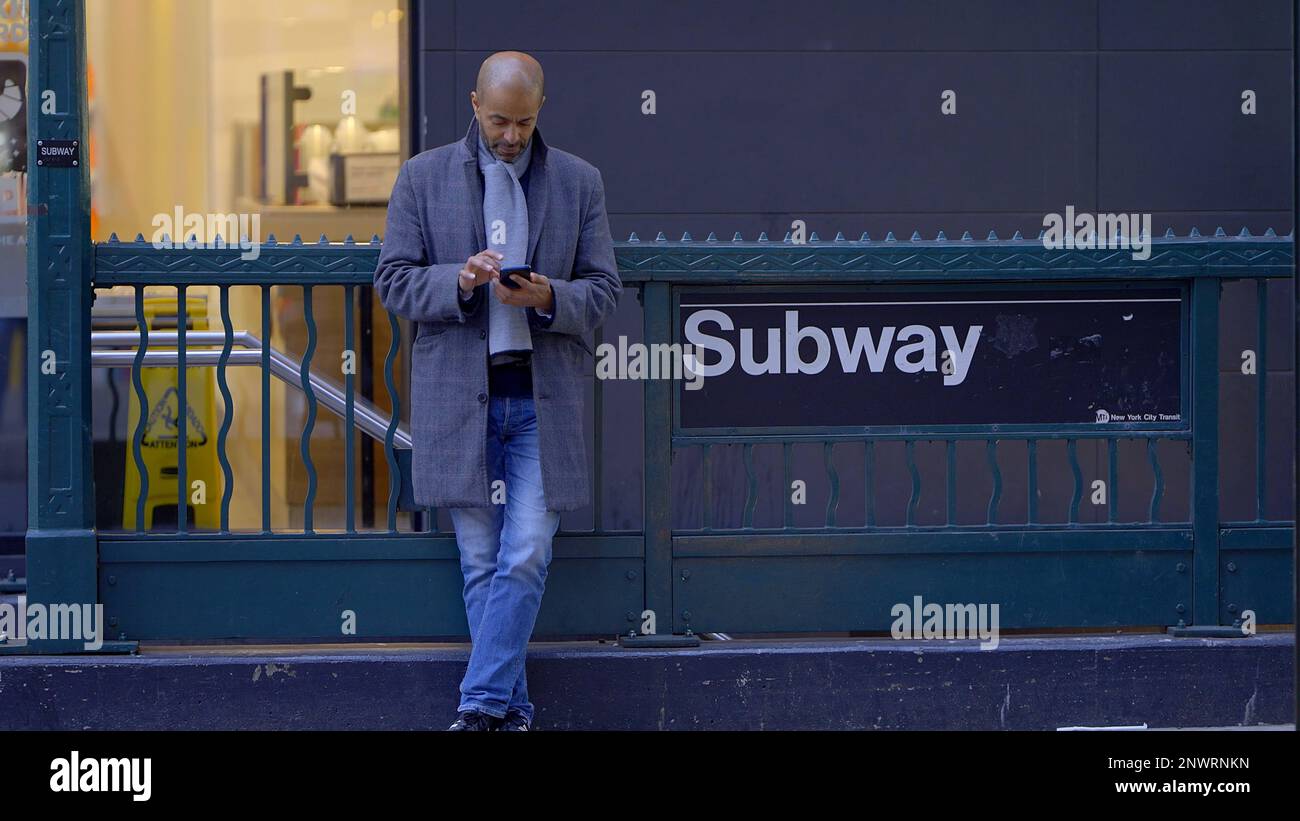 Man waiting at a subway entrance in New York - street photography Stock ...