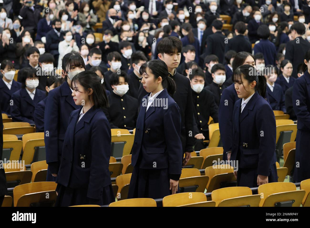 3rd grade high school students with and without masks attend their graduation ceremony in ...