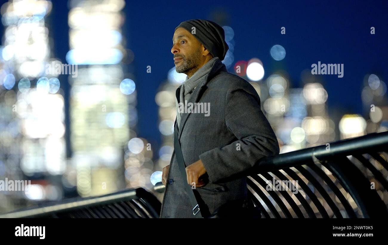 Man standing at the waterfront with Manhattan skyline - street ...