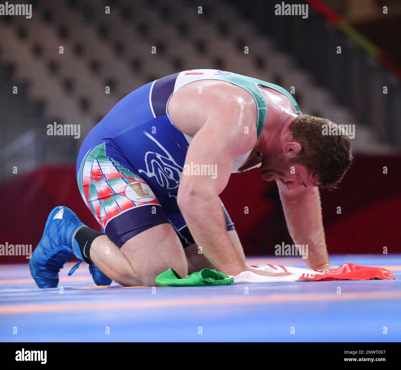 Iran's Hadibasmanj Parviz celebrates after winning the Wrestling Men's ...