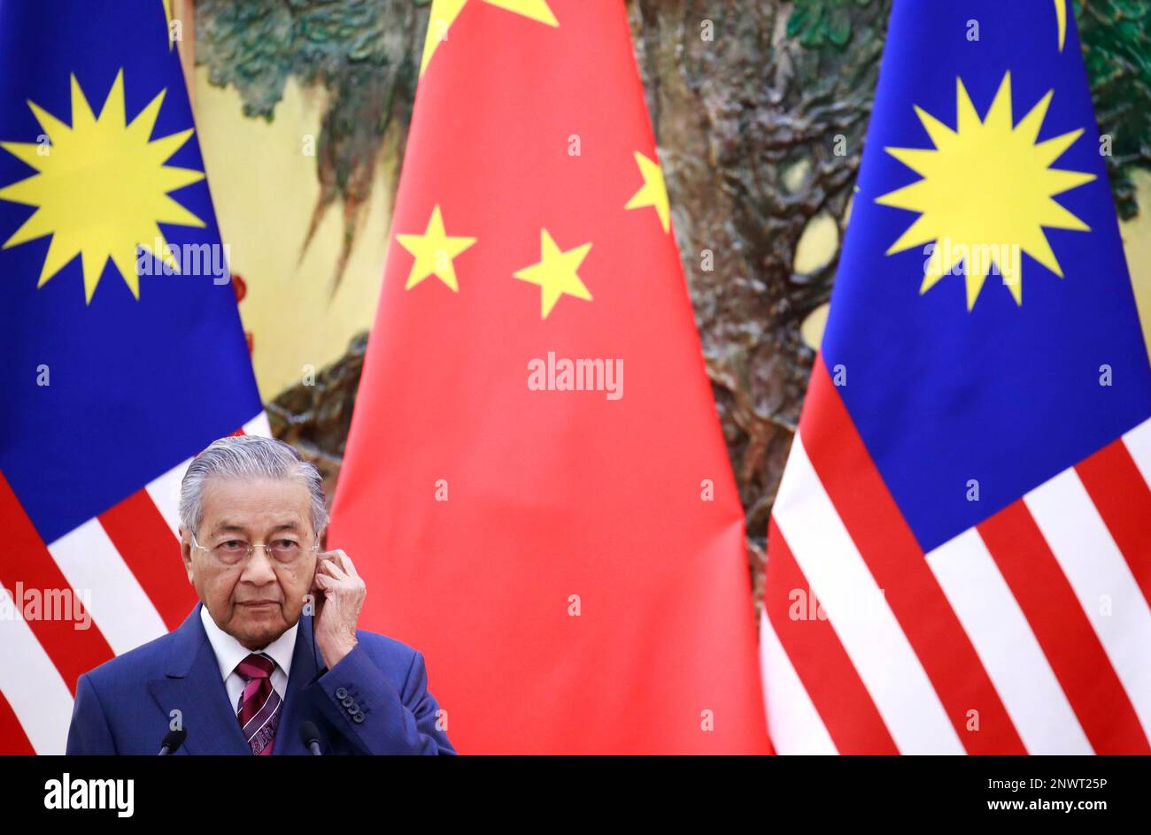 Malaysian Prime Minister Mahathir Mohamad adjusts his earphones during ...