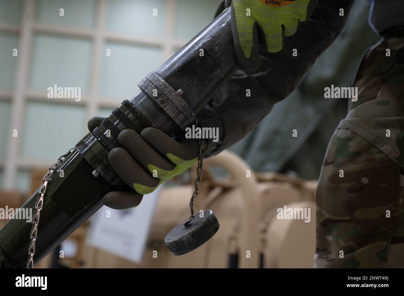 An Airman connects the generator power distribution plug to an ...