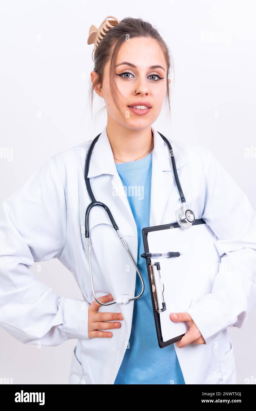 Portrait of smiling female doctor in medical gown standing isolated on ...