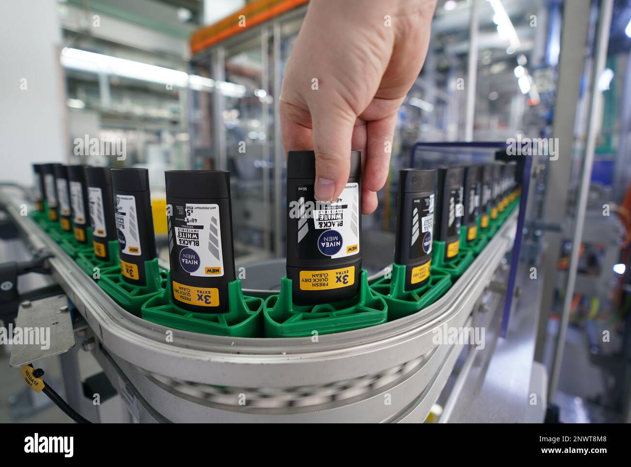 Hamburg, Germany. 28th Feb, 2023. An employee reaches for a Nivea Men ...