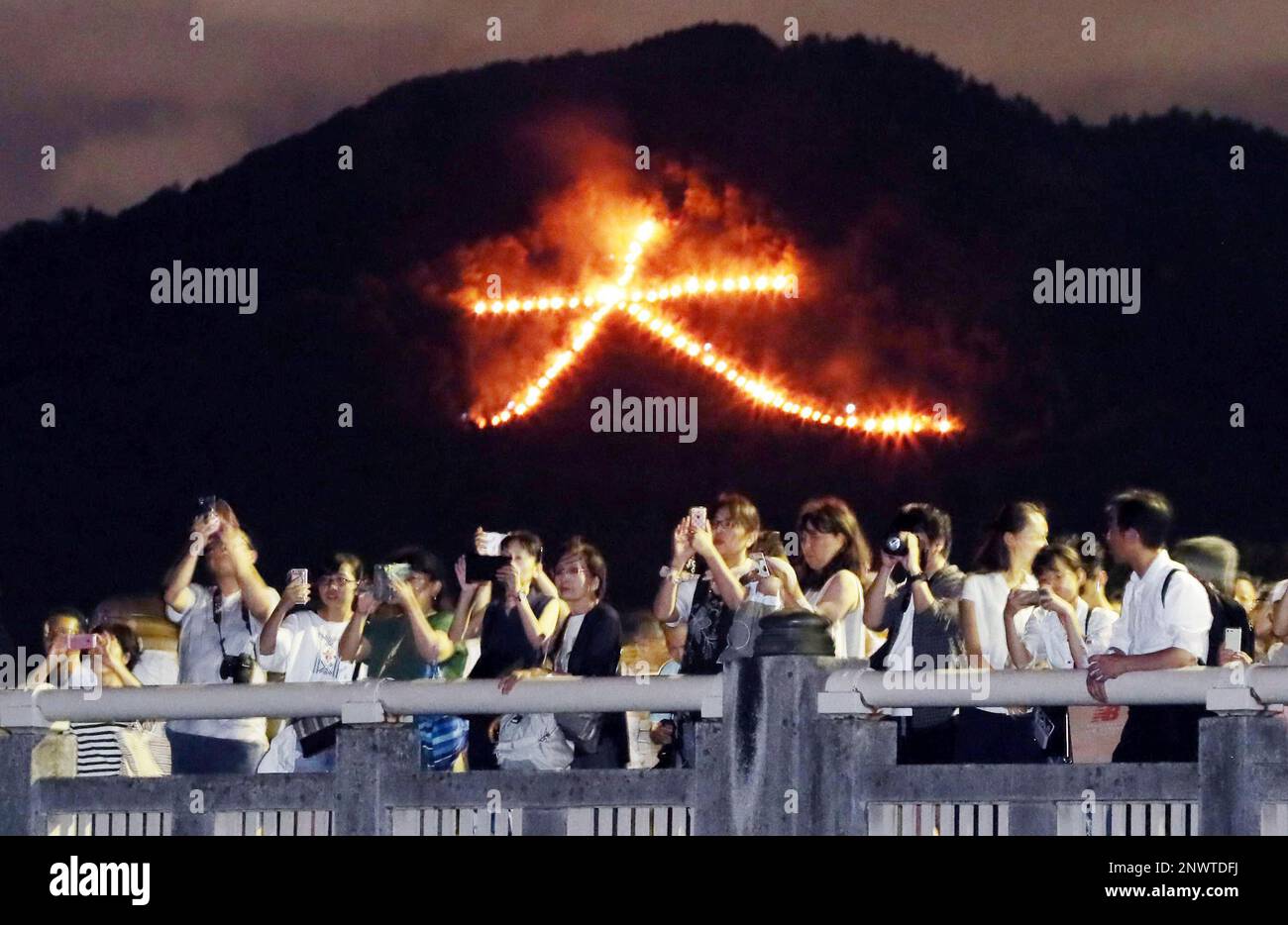 Visitors enjoy looking Chinese gigantic character "dai," meaning " big ...