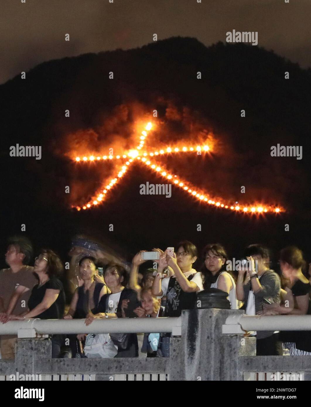 Visitors enjoy looking Chinese gigantic character "dai," meaning " big ...