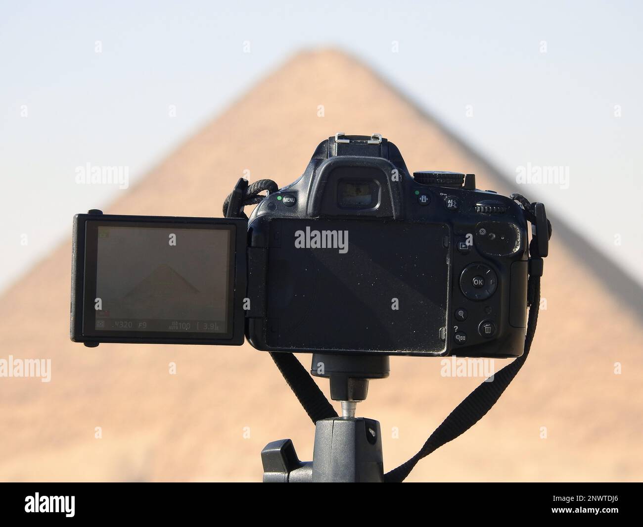 A digital DSLR camera on a tripod Photographing The red north pyramid ...