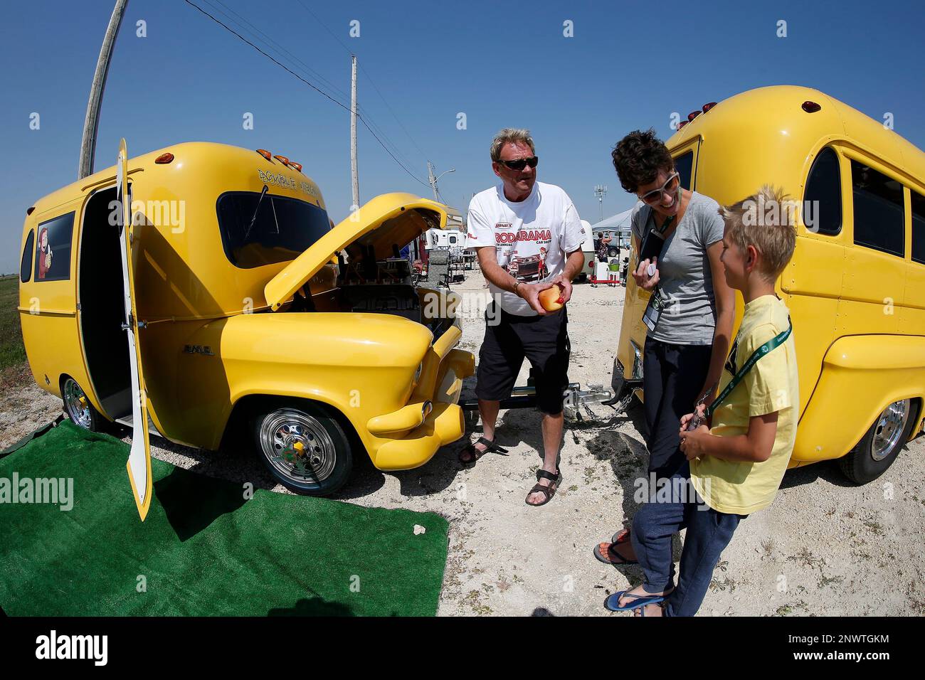 Ron Schellenberg shows off his engine barbecue in his yellow school bus ...