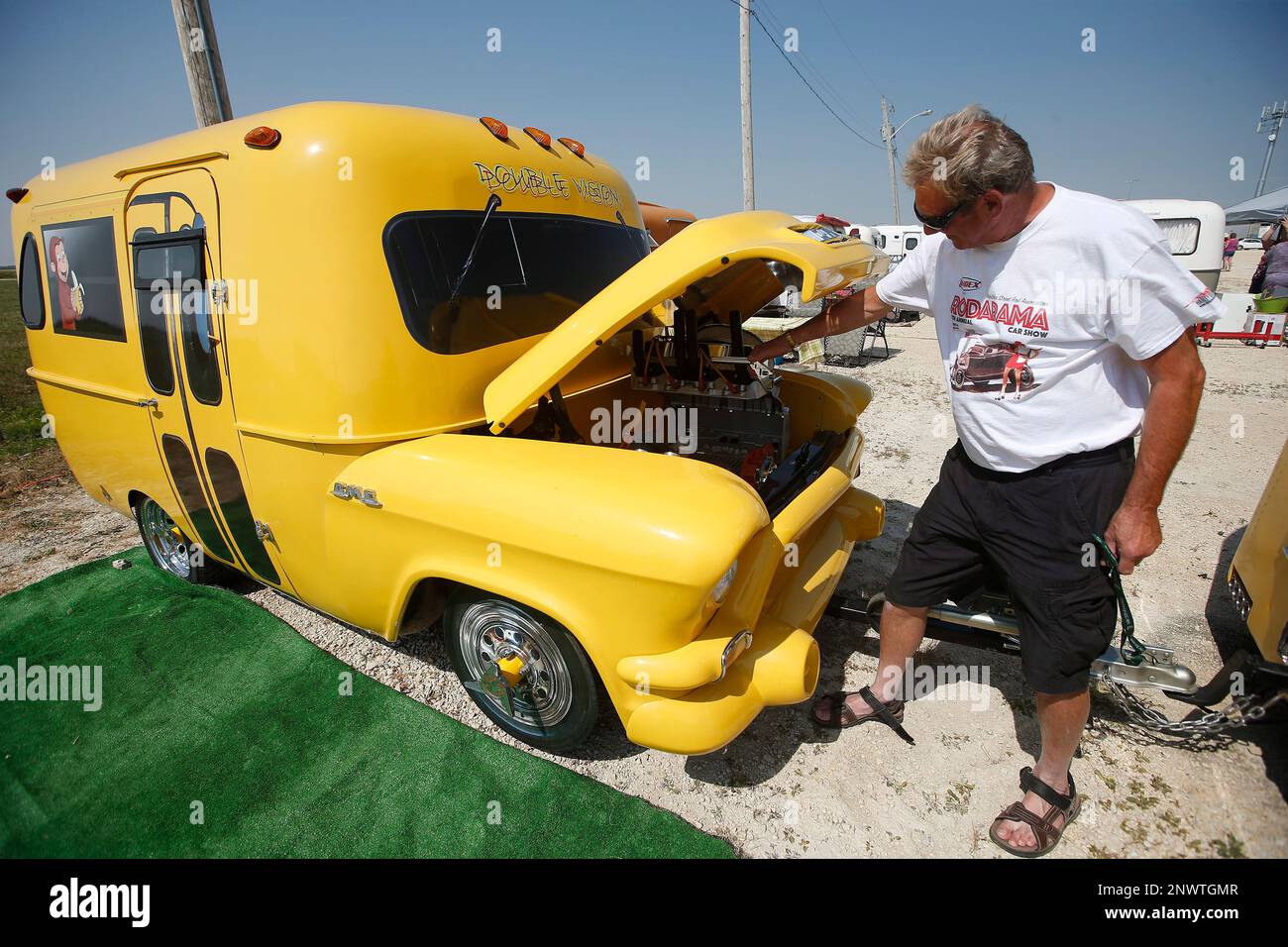Ron Schellenberg shows off his engine barbecue grill in his yellow ...