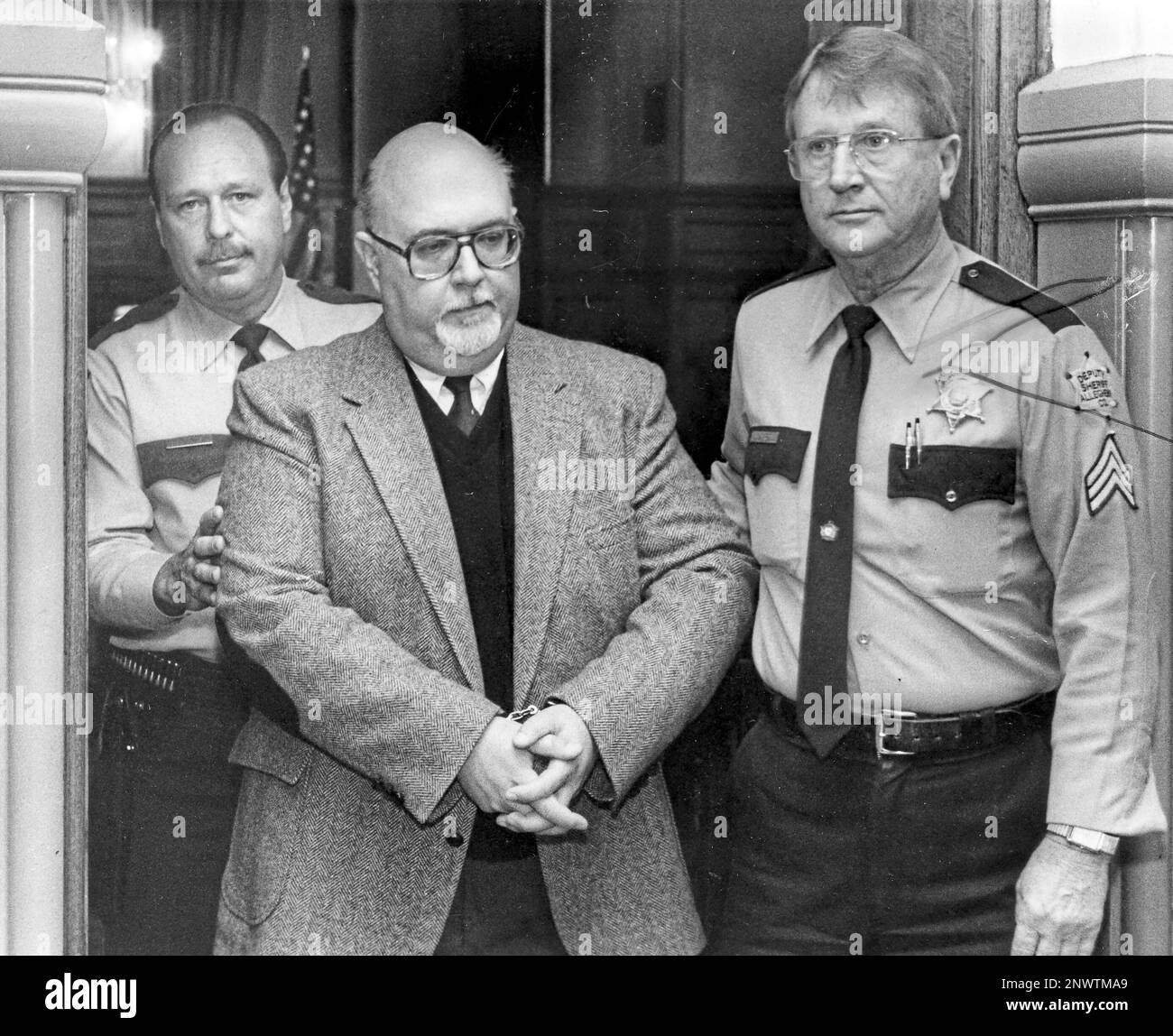 The Rev. Robert Wolk, a Roman Catholic priest, is led from the ...