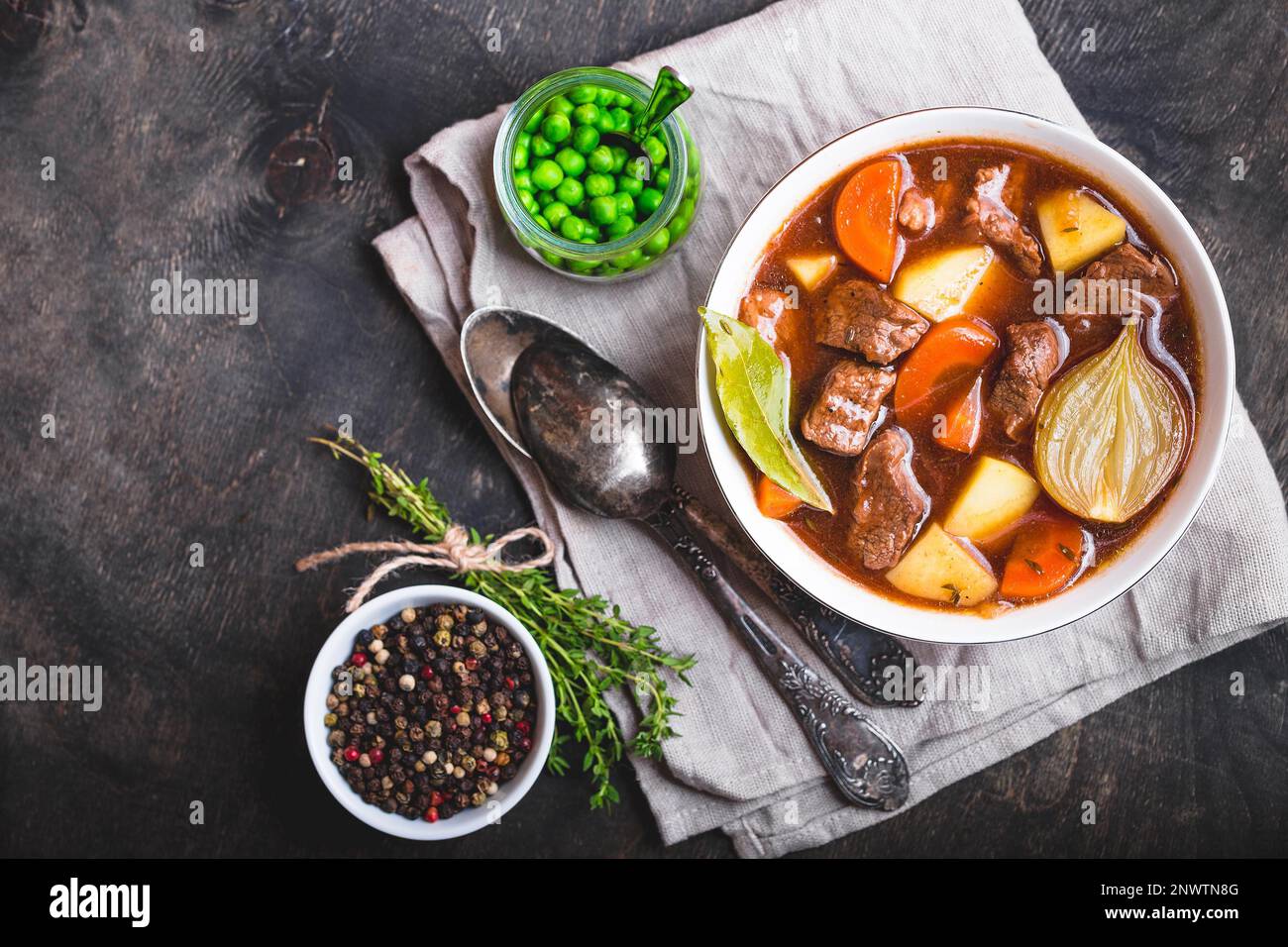 Meat stew with beef, potato, carrot, onion, spices. green peas. Slow ...
