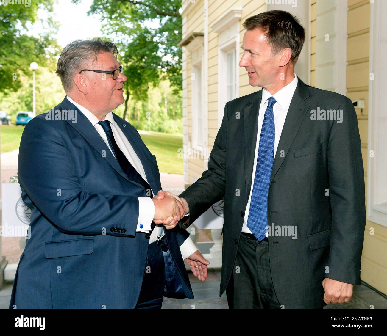 Finland's Minister for Foreign Affairs Timo Soini, left, shakes hands ...