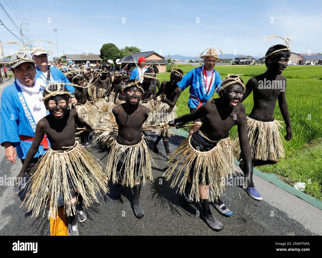 Children, wearing a straw-demons style, walk around the streets drawing ...