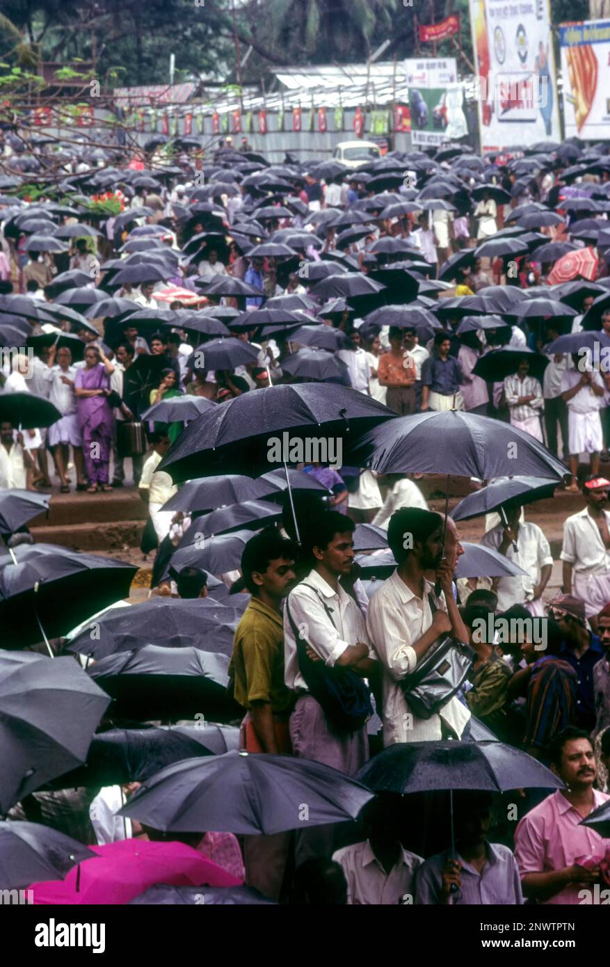 Crowd with umbrellas in raining during Pooram festival in Thrissur or ...