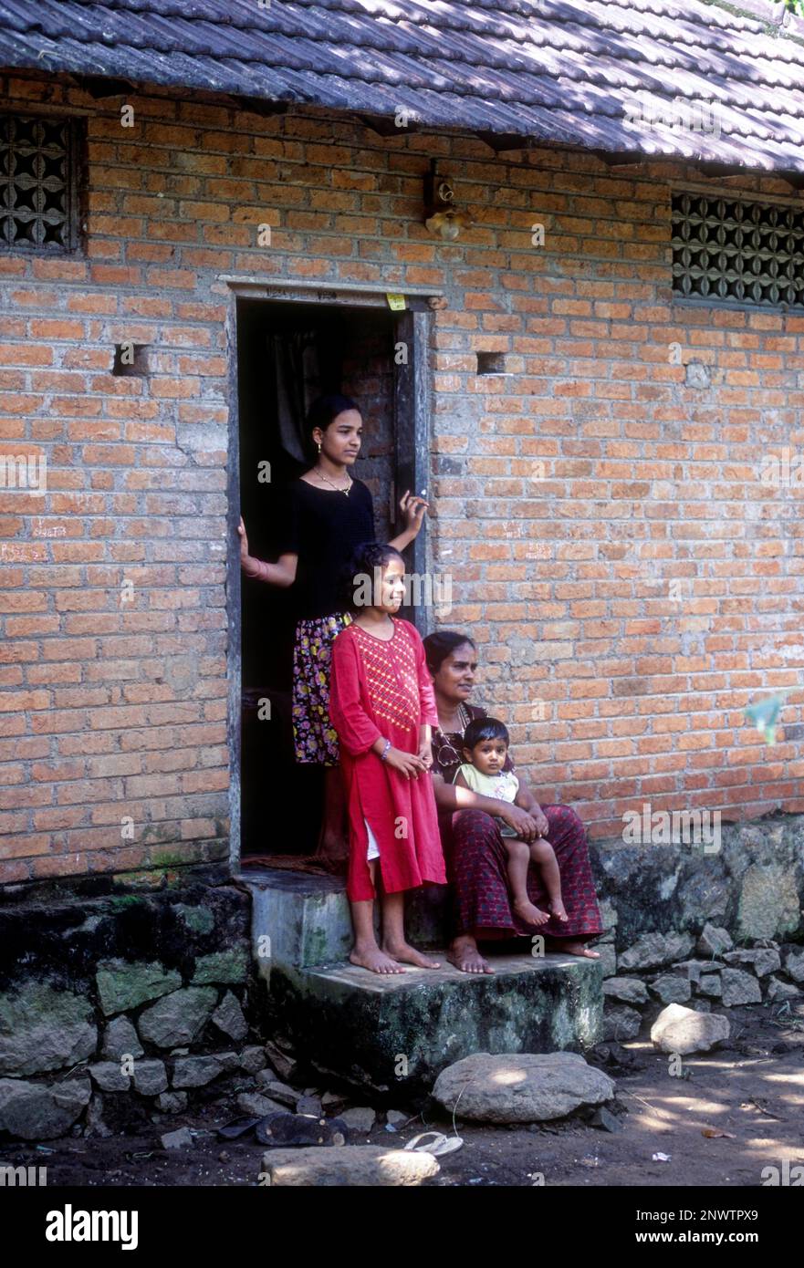 Family members watching from doorway of the house in Kuttanad, Kerala ...