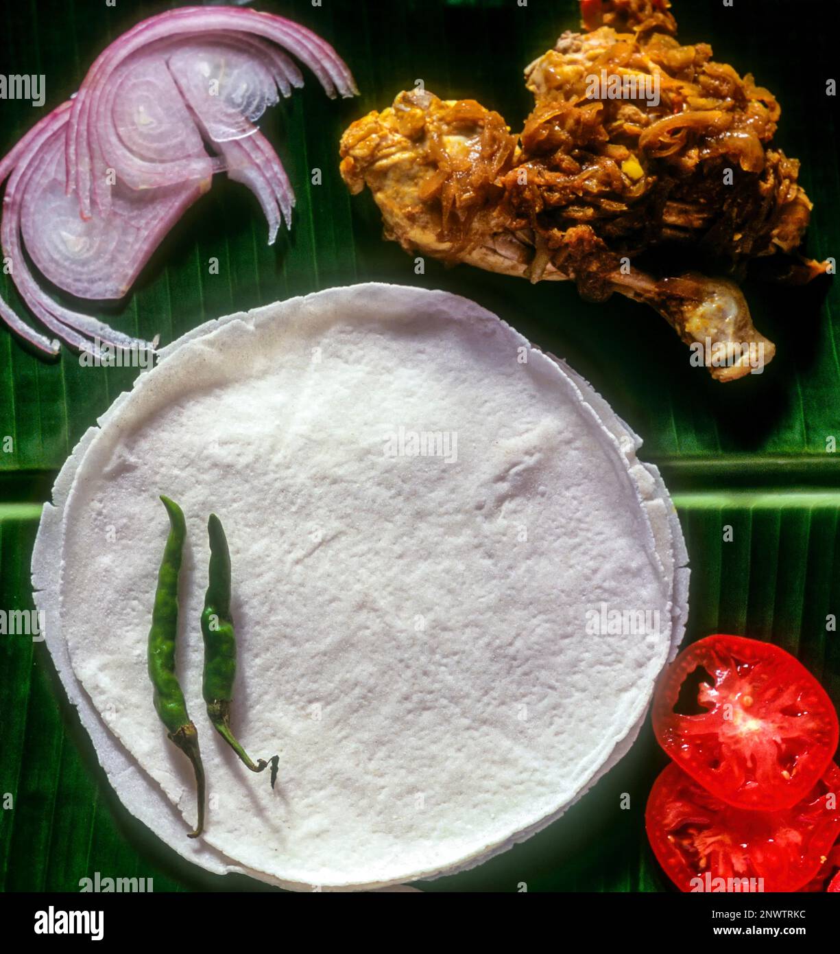 Pathiri with chicken in banana leaf. Pathiri is a traditional food of ...