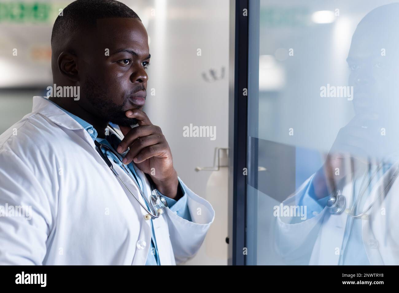 African american male doctor with stethoscope thinking in hospital ...