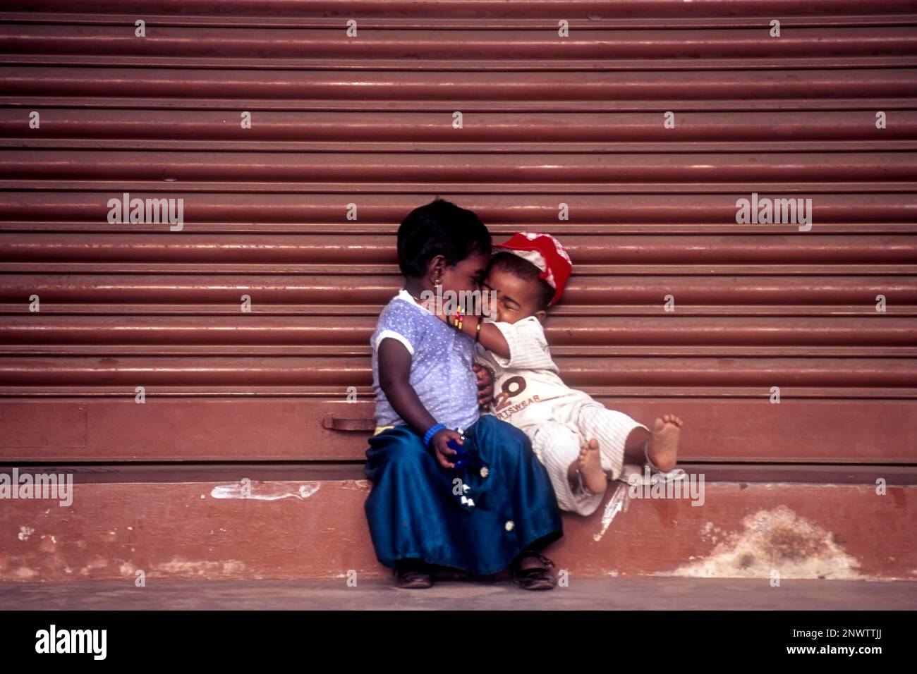 Two kids hugging and playing in front of the shop in kerala, India ...